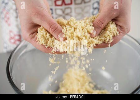 Rubbing butter into flour and sugar mixture, to make sweet crumble ...