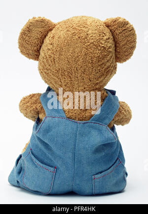 back view of a teddy bear wearing tartan plaid pants sitting on beach ...