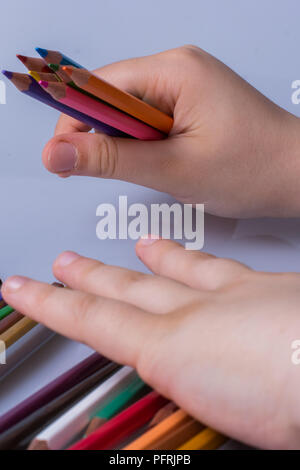 Hand holding color Pencils placed on a white background Stock Photo - Alamy