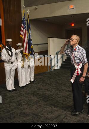 U.S. Marine Corps veteran Harold Berg, who fought in World War II, lays ...