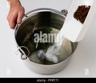 salt food close up cooking in a pot. homemade meal add salt spices ...
