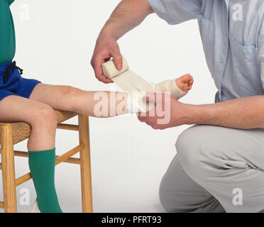 wrapping the sprained foot Stock Photo - Alamy