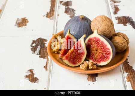 Fig walnuts cinnamon anise on a plate of old wooden background Stock ...