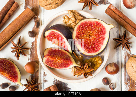 Fig walnuts cinnamon anise on a plate of old wooden background Stock ...