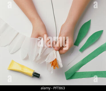Close up of hands holding wrapping gift box on wooden table with xmas ...