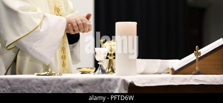 catholic priest hands serving mass at a liturgy. Images shows various ...