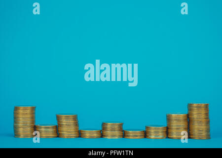 Columns of coins, piles of coins on blue background, business and ...