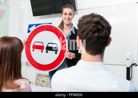 Driving instructor explaining meaning of street sign to class Stock ...
