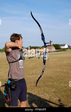 male archer using a bow for target practice at an archery club Stock ...