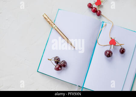 red hearts and note book on a table Stock Photo - Alamy