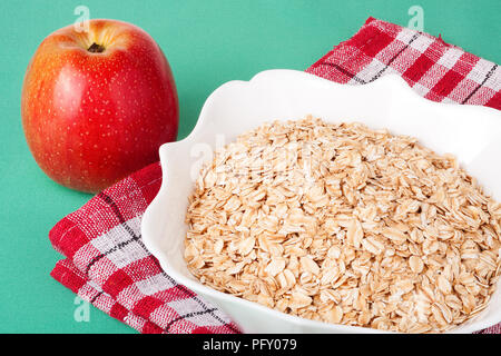apple with oat flakes in bowl Stock Photo - Alamy