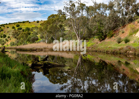 Onkaparinga River on a sunny day with reflections of trees and cliffs ...