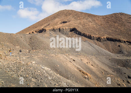 Women trekking around a volcanic crater in Fuerteventura, Canary ...