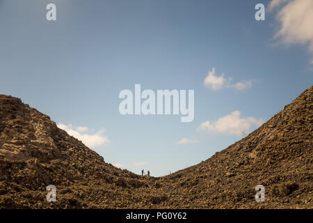 Couple standing in Caldera de Gairia volcano cone in Fuerteventura ...