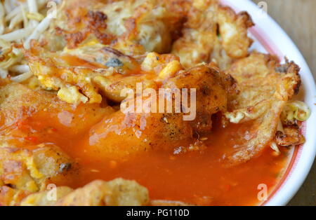fried mussel omelet dressing chili sauce on dish Stock Photo - Alamy