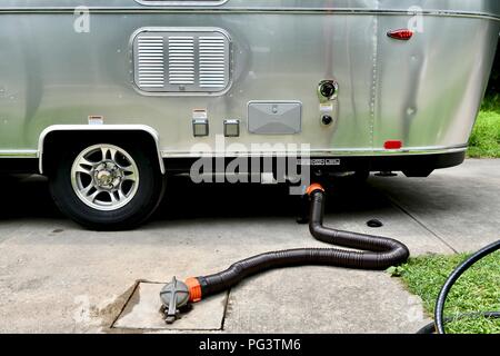 Airstream travel trailer at the dump station emptying its grey water ...