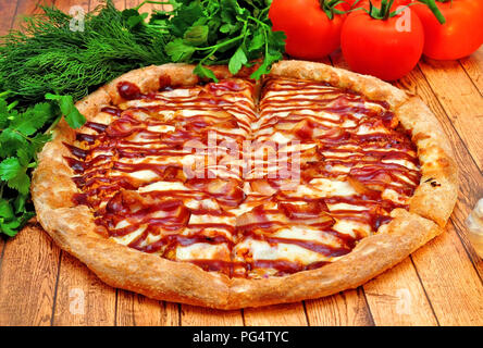 big Pizza with a barbecue on a wooden table Stock Photo - Alamy