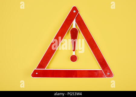 Bright red and yellow triangle warning road sign with exclamation mark ...