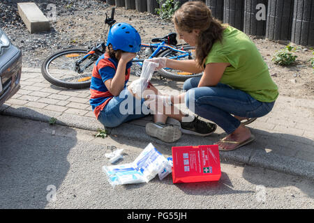 bike accident and first aid. Biker crash crashes, injuring knee and leg ...