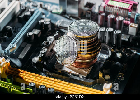 close up view of pile of bitcoins on computer motherboard Stock Photo ...