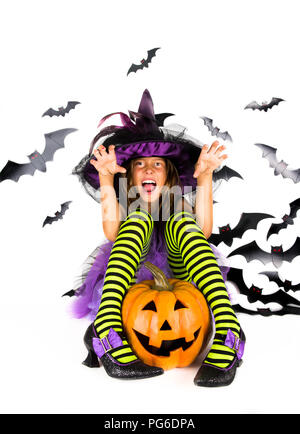 happy witch kid with pumpkin jack o lantern wear costume of wizard on ...