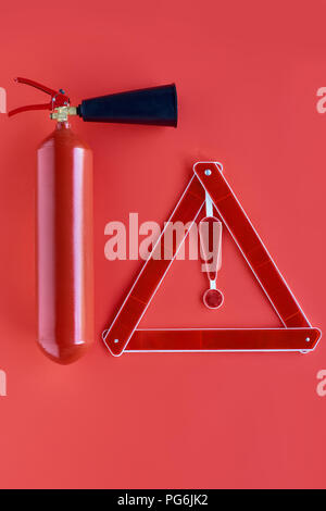 Emergency warning triangle, red fire extinguisher and first aid kit on ...