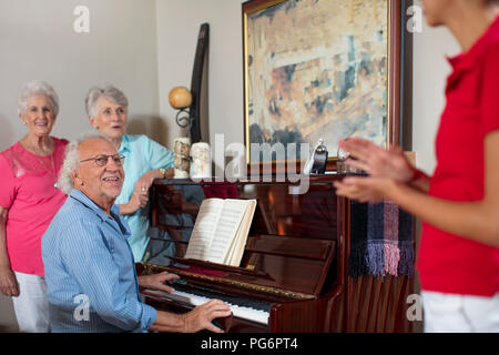 elderly playing instrument in a group lead by a retired old orchestra ...