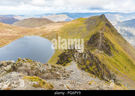 Helvellyn mountain peak and Red Tarn corrie lake, Lake District ...
