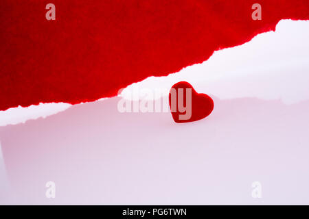 Heart near torn red paper on a white background Stock Photo - Alamy