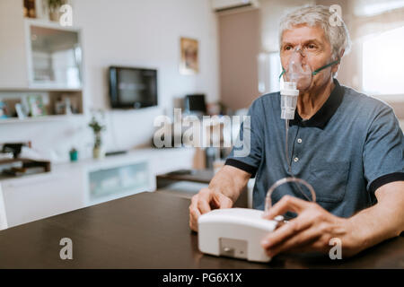 Old man using asthma inhaler Stock Photo - Alamy