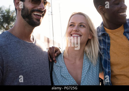 Three happy friends outdoors Stock Photo - Alamy