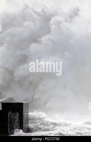 Huge stormy wave splash over pier and beacon - used infrared filter ...