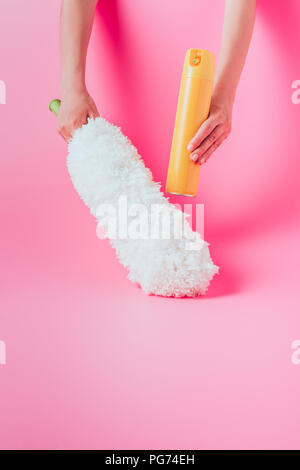 cropped image of female cleaner holding cleaning fluid and rag, pink ...