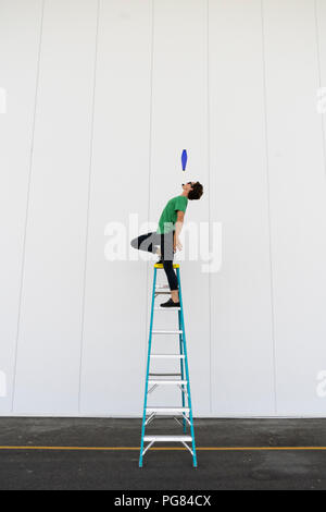 Male acrobats having fun while standing on footpath Stock Photo - Alamy