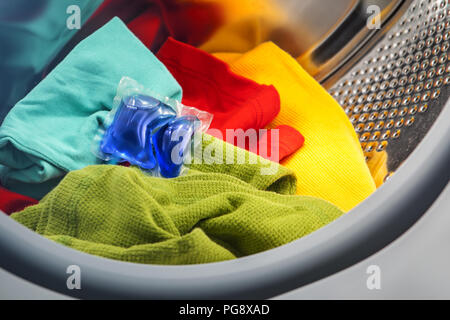 blue gel caps in washing mashine, liquid coloured detergent Stock Photo ...