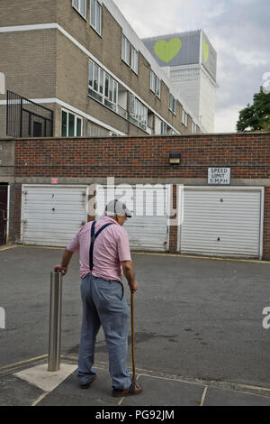 Local resident walks past run-down apartment block by the Grenfell ...
