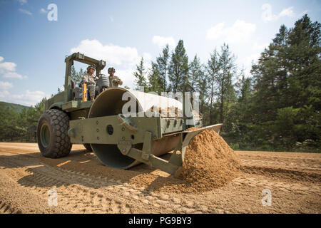 U.S. Soldiers from the 808th Engineer Company are laying cinder blocks ...