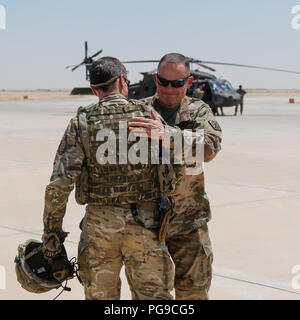 U.S. Army Col. Michael Maddox, right, Al Asad Air Base (AAAB) commander ...