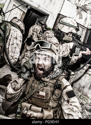 Soldier is using radio for communication during military operation in ...