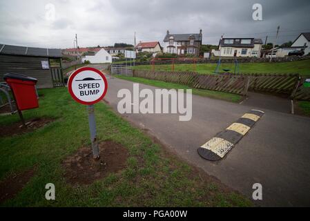 Speed bump warning sign beside a road next to a speed bump Stock Photo ...