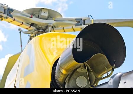 Close up of the rotors blades of a yellow Helicopter against a bright ...