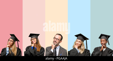 Senior teacher with his graduate students thinking and looking up ...