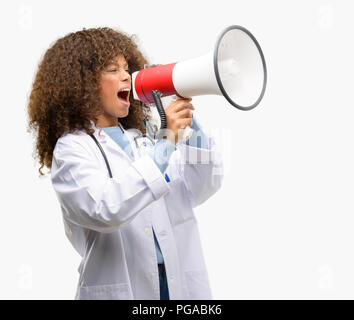 Young woman yelling to loudspeaker concept Stock Photo - Alamy