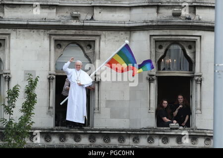 A rainbow flag is flown next to a likeness of Pope Francis as crowds ...