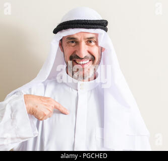 Senior arabic man with surprise face pointing finger to himself Stock ...