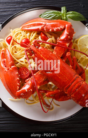 Luxury food recipe: spaghetti and boiled lobster, tomatoes, lemon and ...