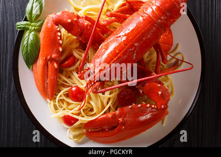 Luxury food recipe: spaghetti and boiled lobster, tomatoes, lemon and ...