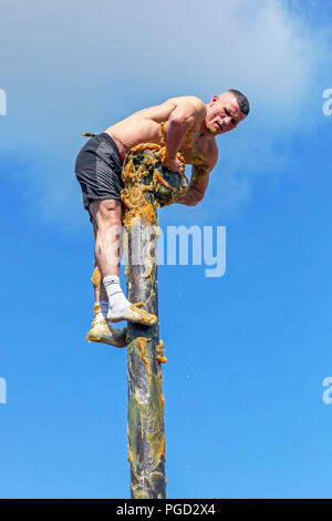 Irvine, UK. 25th Aug 2018. Climbing the greasy pole, a 10 metre ...