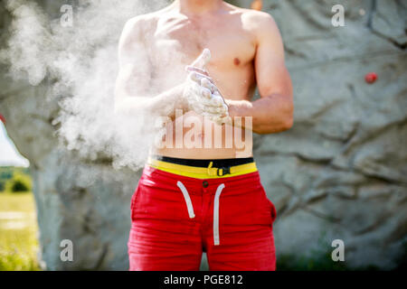 Photo of climber man with talc in hands Stock Photo - Alamy