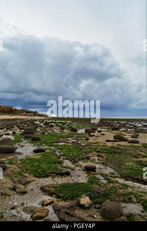 Hunstanon beach, with rock pools and storm clouds blowing in Stock ...